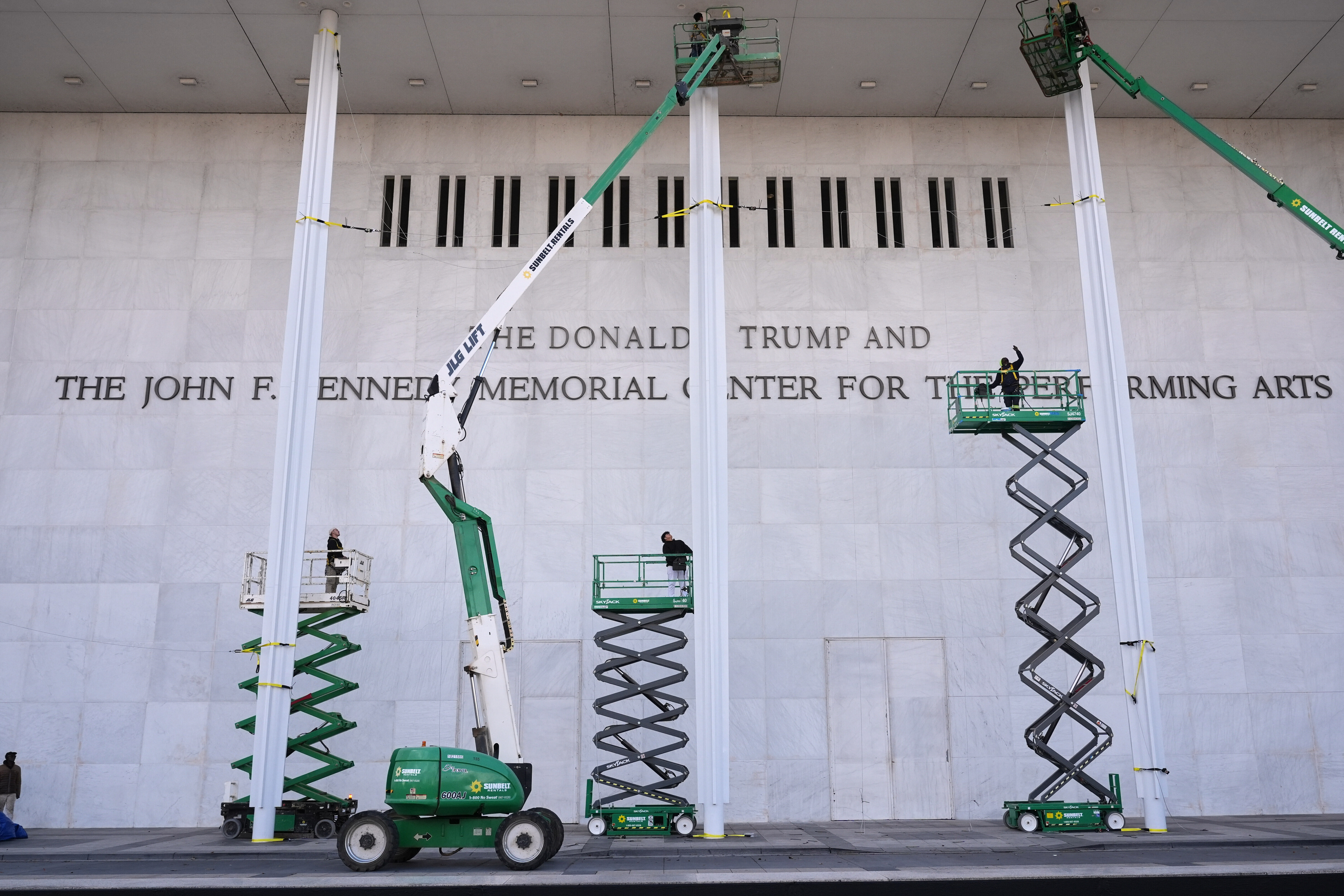 Photos of Trump's name being added to the Kennedy Center | khou.com