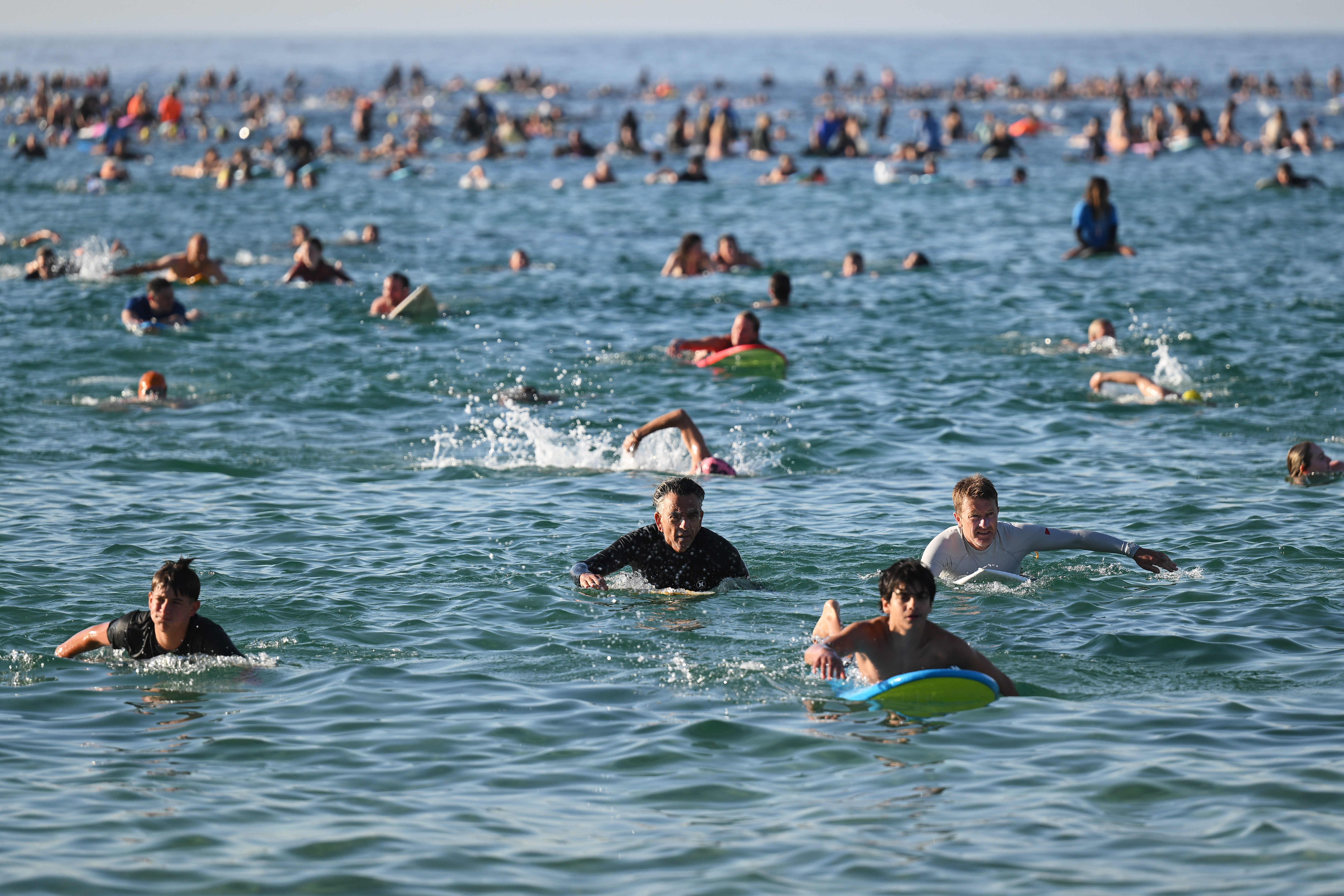 A sunrise crowd gathers at Bondi Beach in solace and defiance after a ...